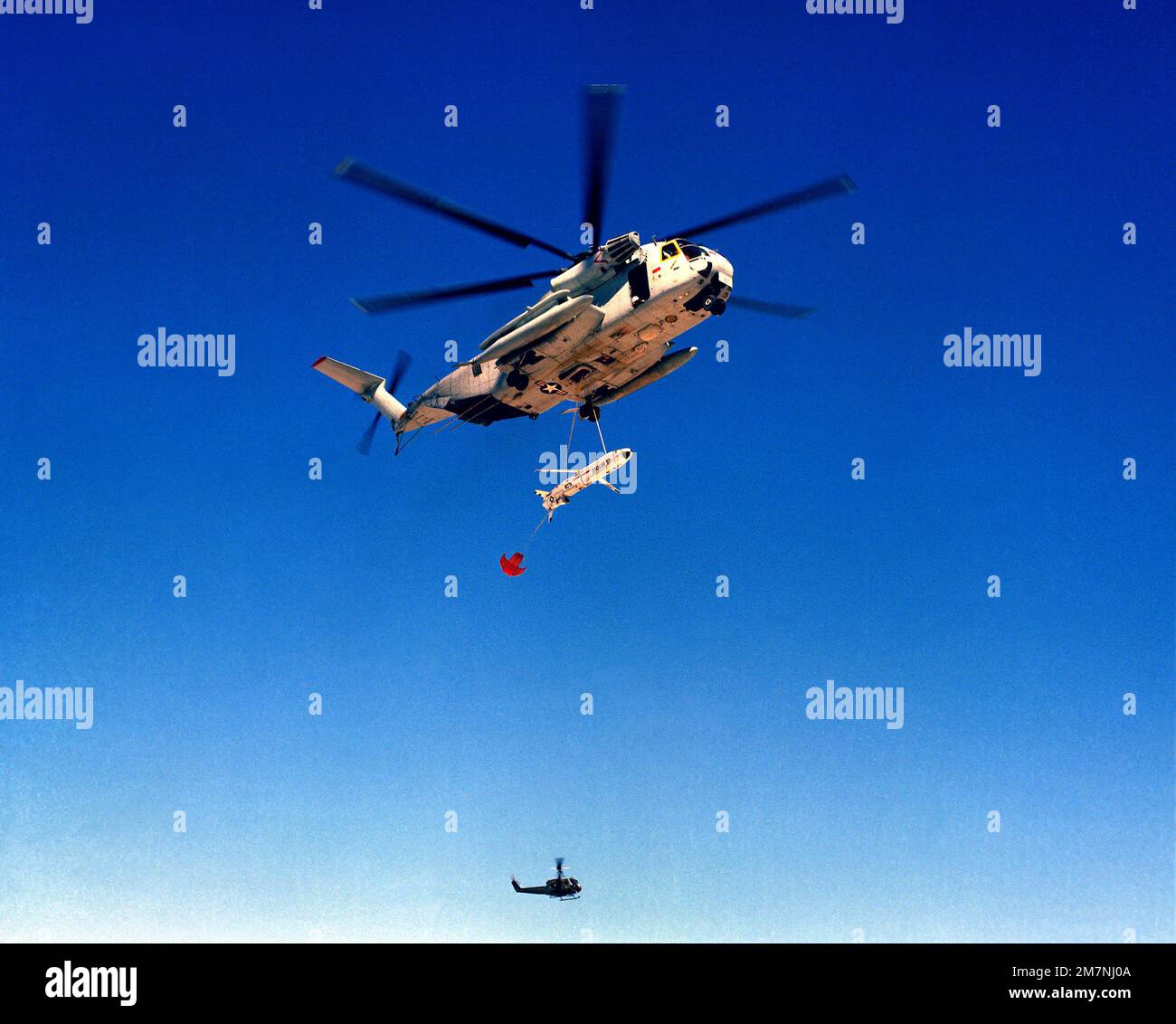 A right front view of an HH-53 Super Jolly helicopter as it picks up an ...