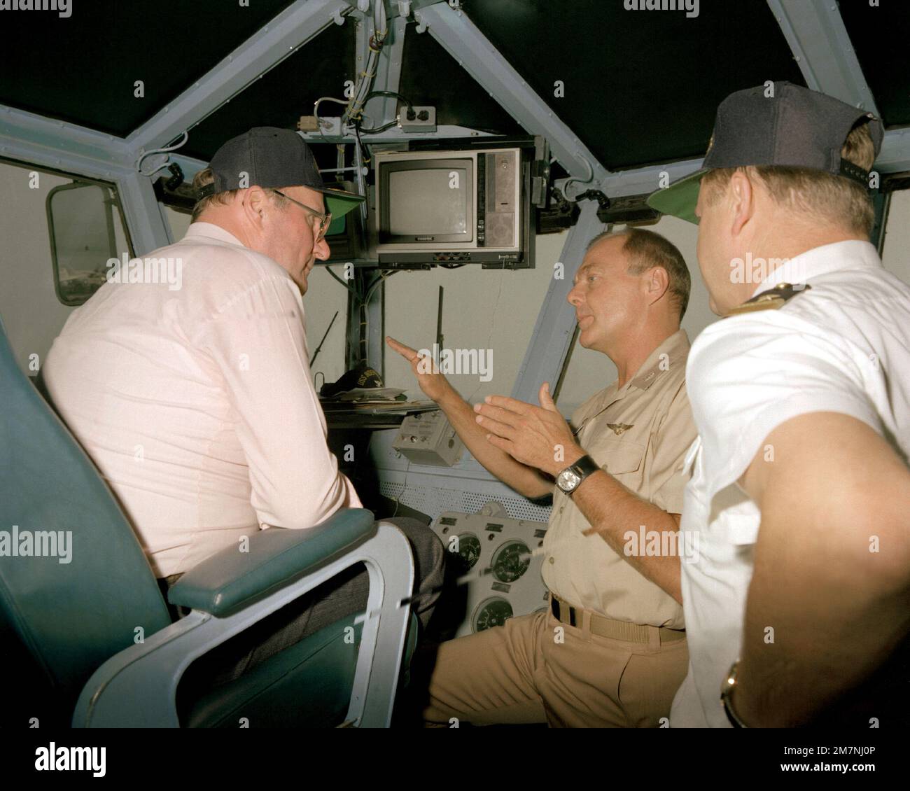 CAPT Thomas C. Watson Jr., center, commanding officer, explains the ...