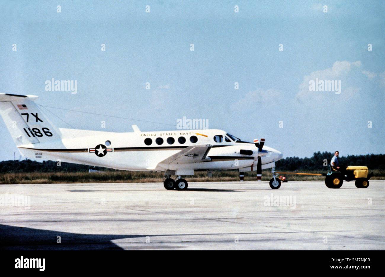 A right side view of a UC-12B transport aircraft being towed out to the ...