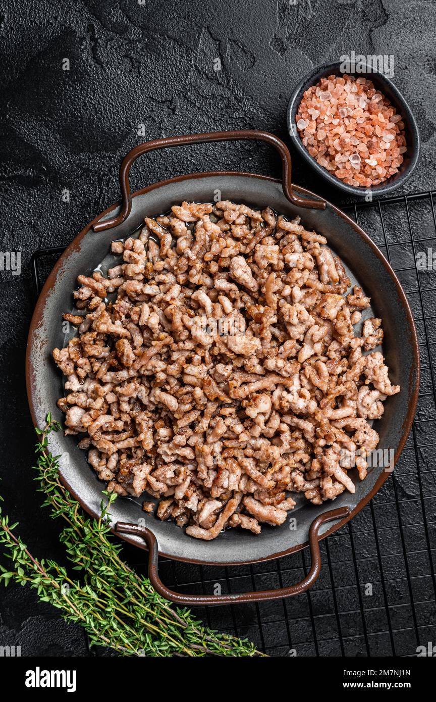 Fried mince beef and lamb meat in a tray with spices. Black background ...
