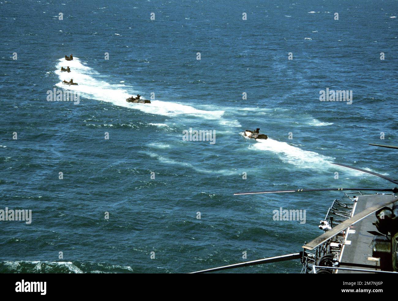 Five LVTP-7 tracked landing vehicles depart the amphibious assault ship ...