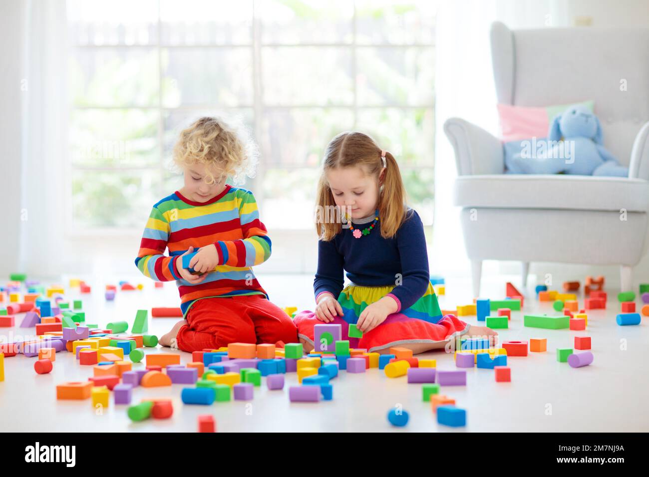 Kids play with wooden toy blocks. Educational colorful toys for ...