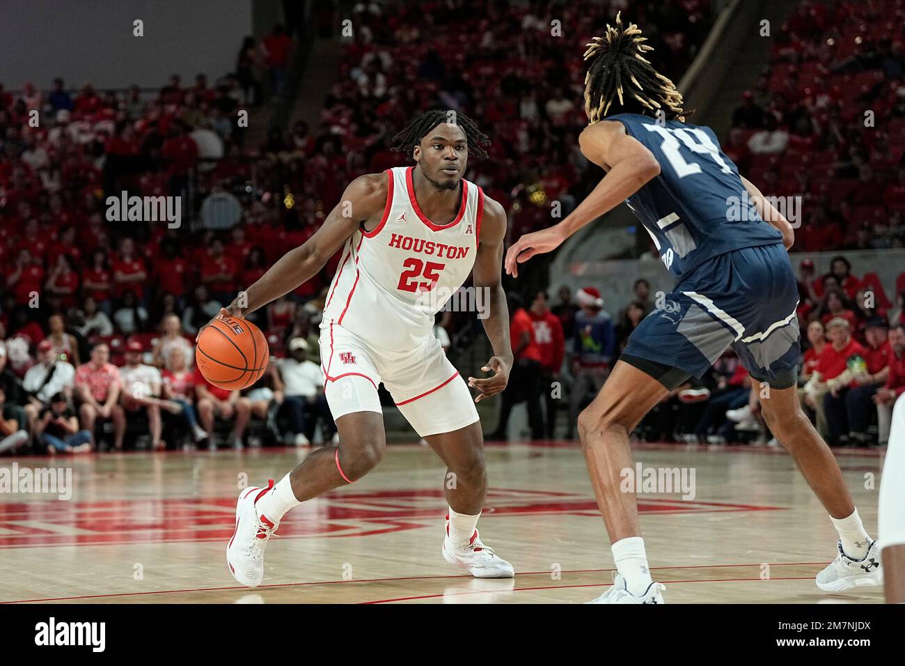 Houston forward Jarace Walker (25) looks for a way around North Florida ...