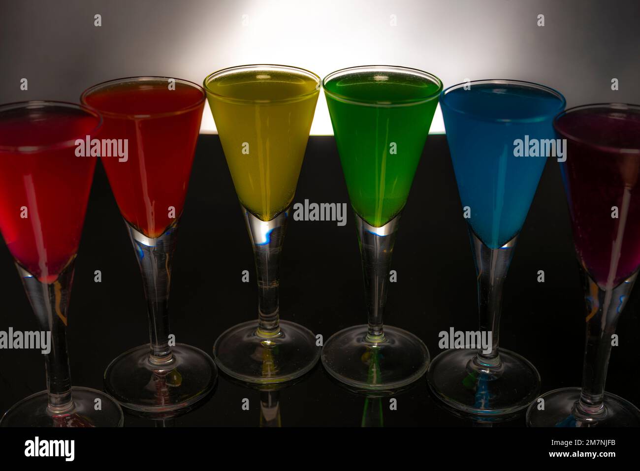 Dark black background with color fresh glass shots Stock Photo - Alamy