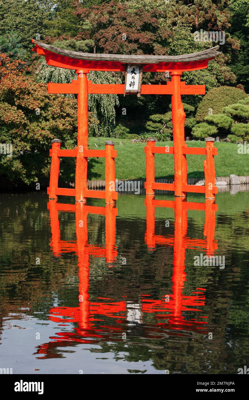 The wooden red-orange Torii in the Japanese garden's pond at the ...