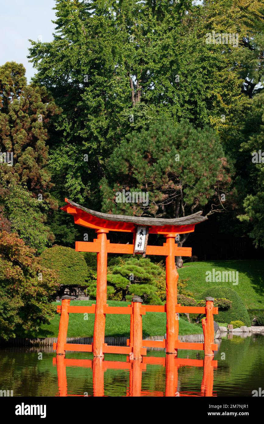 The wooden red-orange Torii in the Japanese garden's pond at the ...
