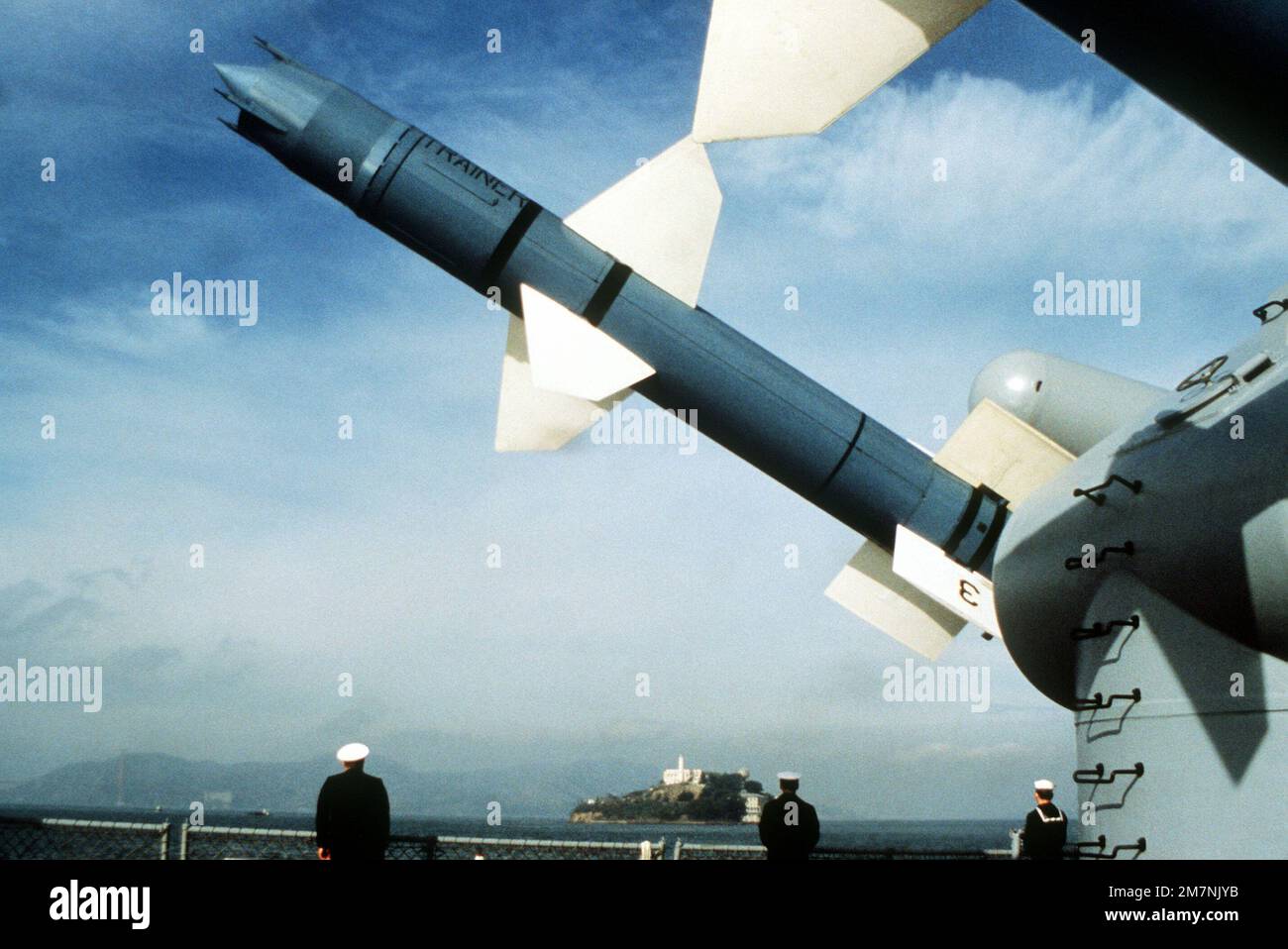 Crewmen line the rail of the guided missile cruiser USS OKLAHOMA CITY ...