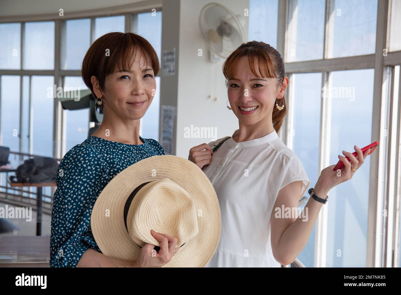 Two Mature Japanese Women Friends Side By Side On A Day Out Looking