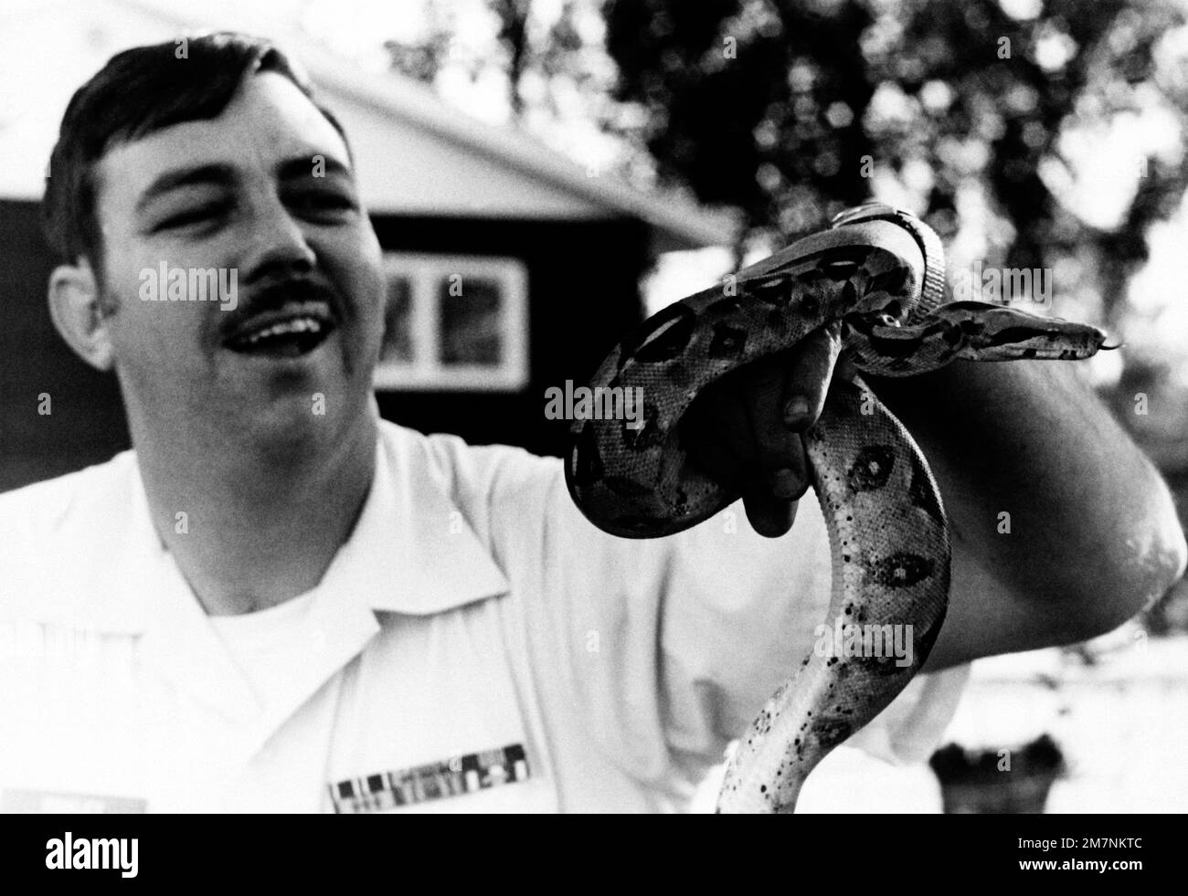 TSGT Eddie Pinkley, 21st Civil Engineering Squadron, holds a boa ...