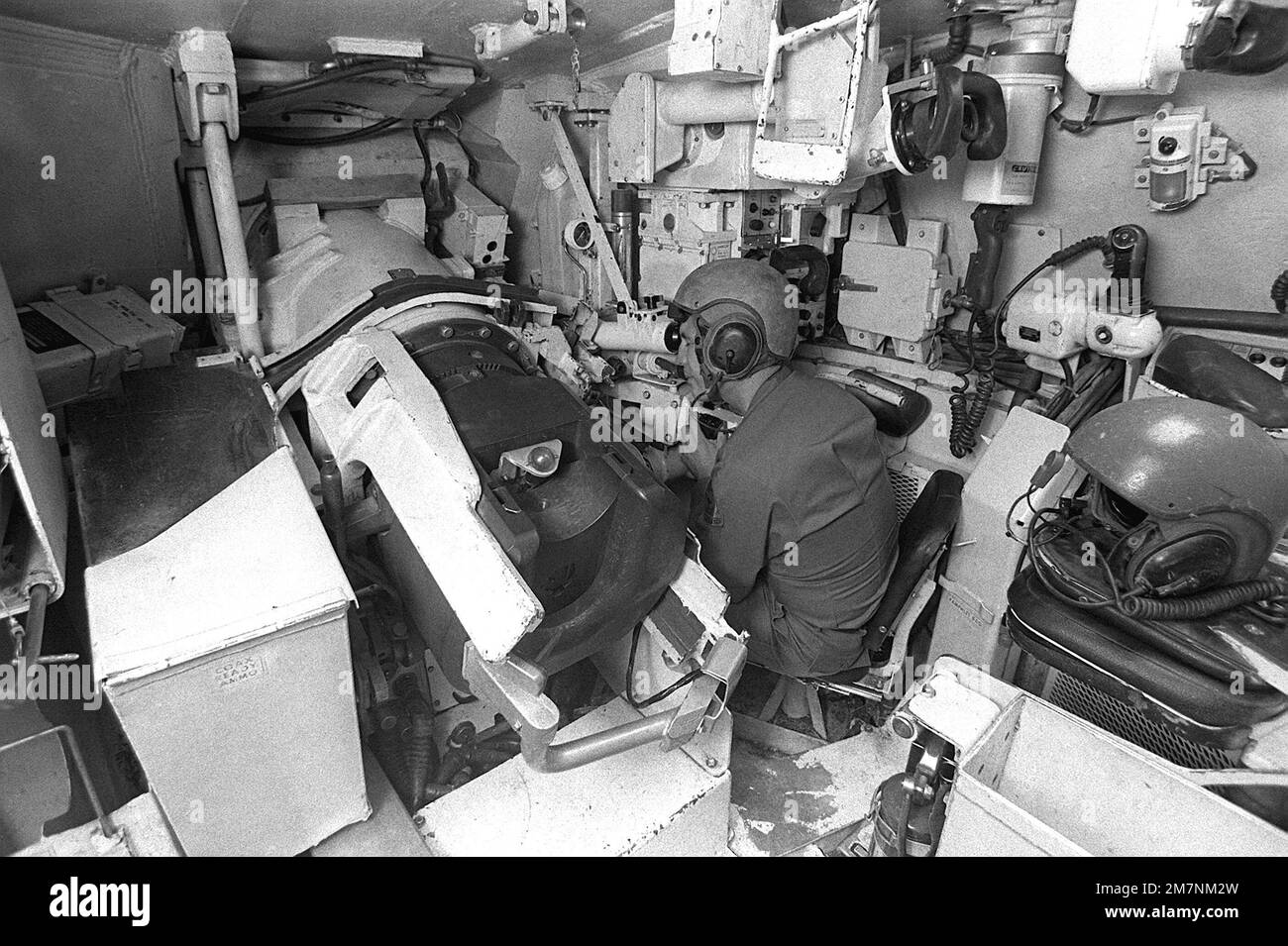 A gunner, inside the XM-1 Abrams tank, checks the fire control system ...