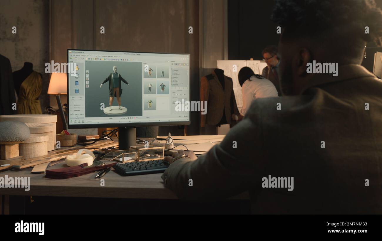 African American tailor or fashion designer creates clothes and ...