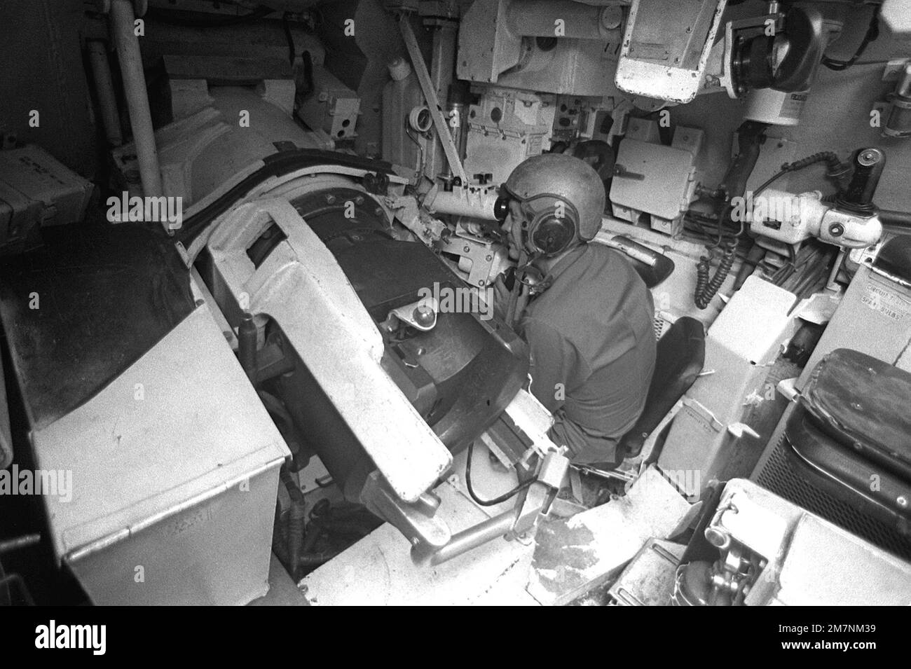 A gunner, inside the XM-1 Abrams tank, checks the fire control system ...
