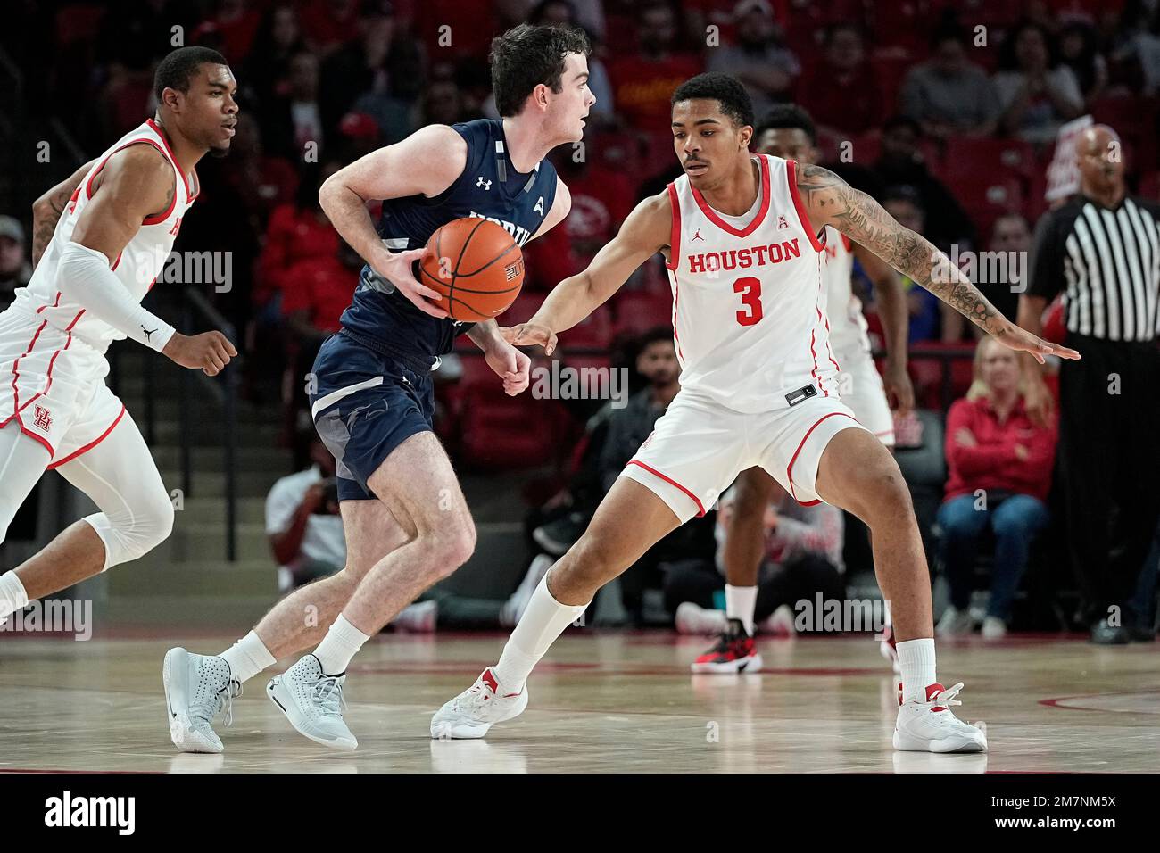North Florida guard Oscar Berry is defended by Houston guard Ramon Walker Jr. (3) during the ...