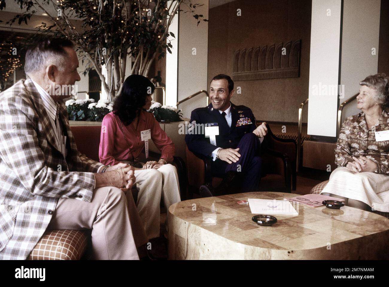 MSGT Wayne L. Fisk relaxes with his wife and family in the lobby of the ...