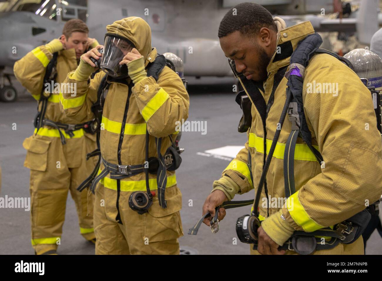 20511-N-VJ326-4037 PACIFIC OCEAN (May 11, 2022) – Sailors don firefighting equipment during a ...