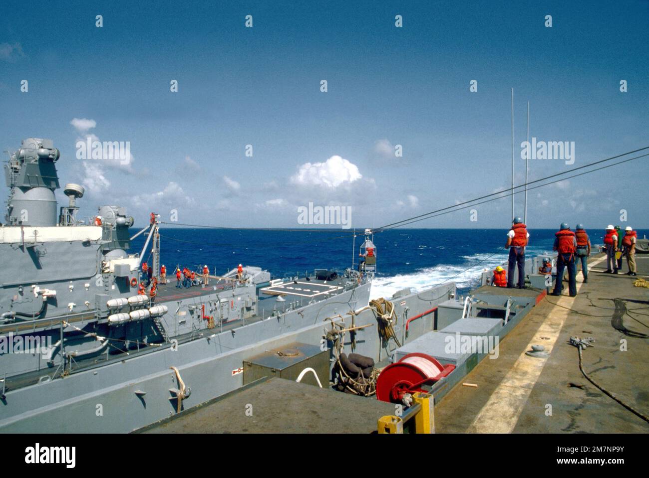 A sailor is transferred by highline from the guided missile destroyer ...