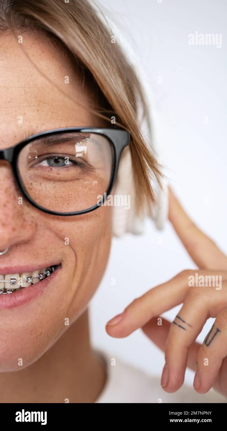 Cropped portrait woman with eyeglasses and dental brakes listening ...