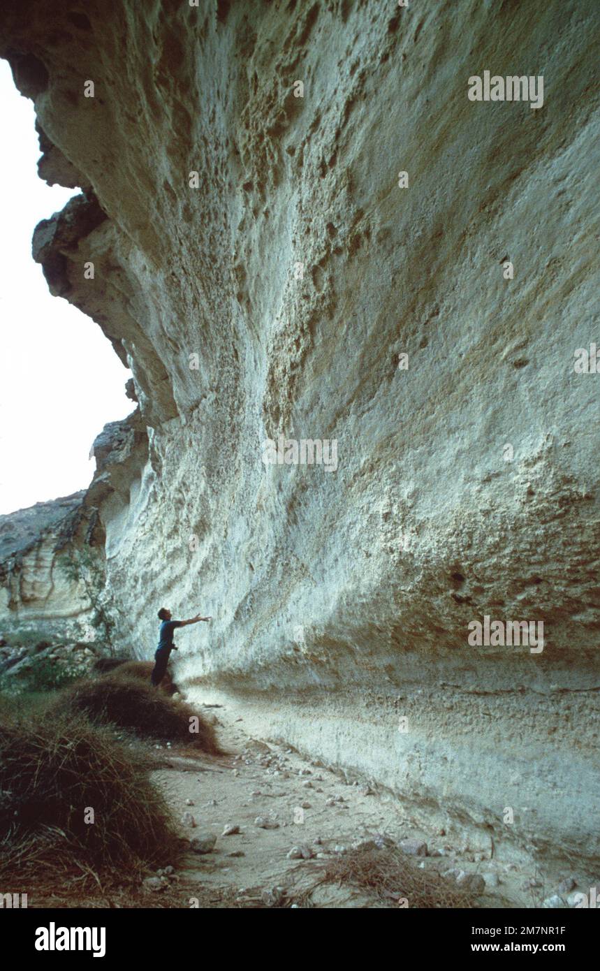 An airman examines a rugged land formation on a sightseeing trip ...