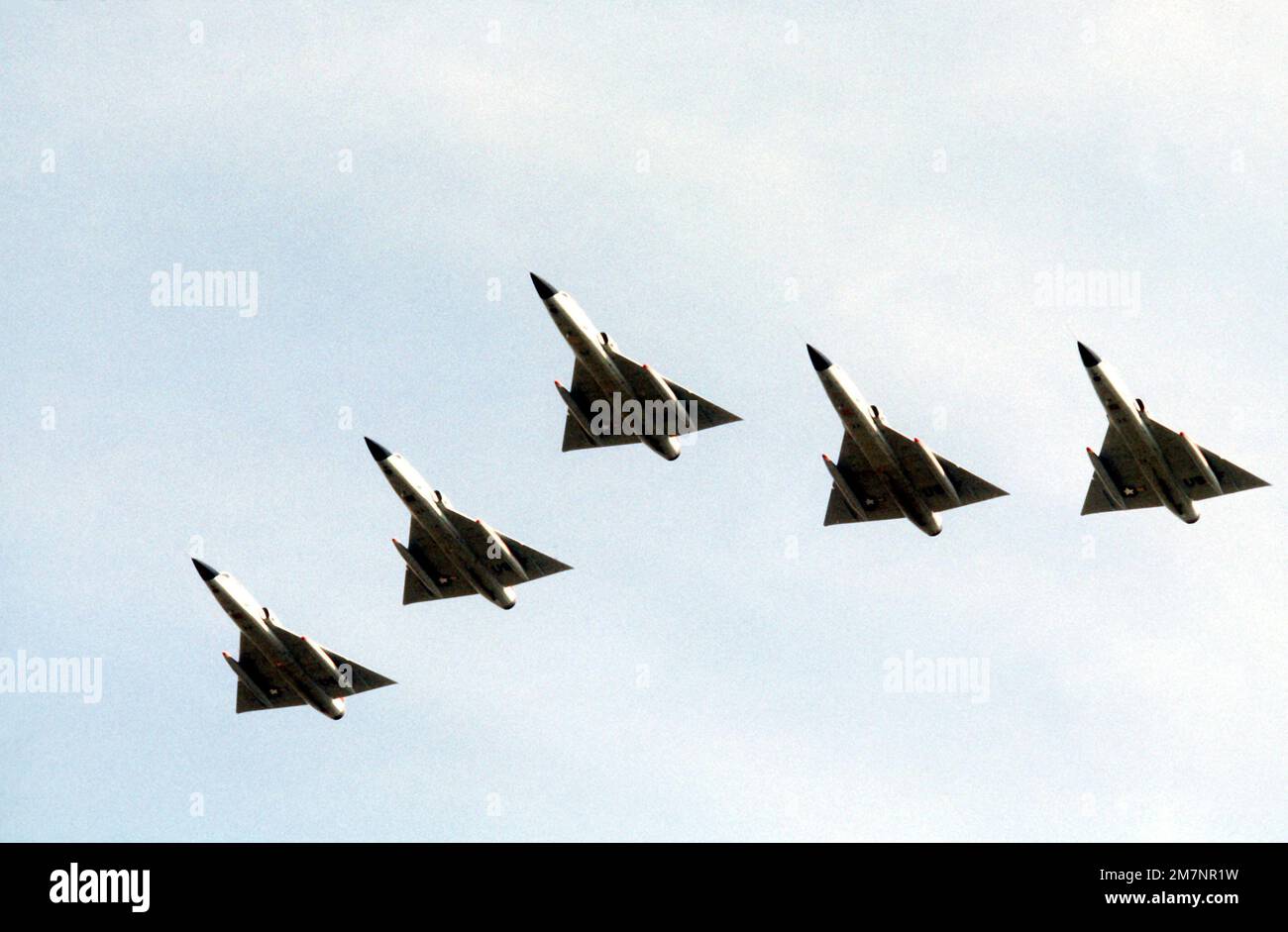 A bottom view of a five-ship wedge formation of F-106 Delta Dart ...