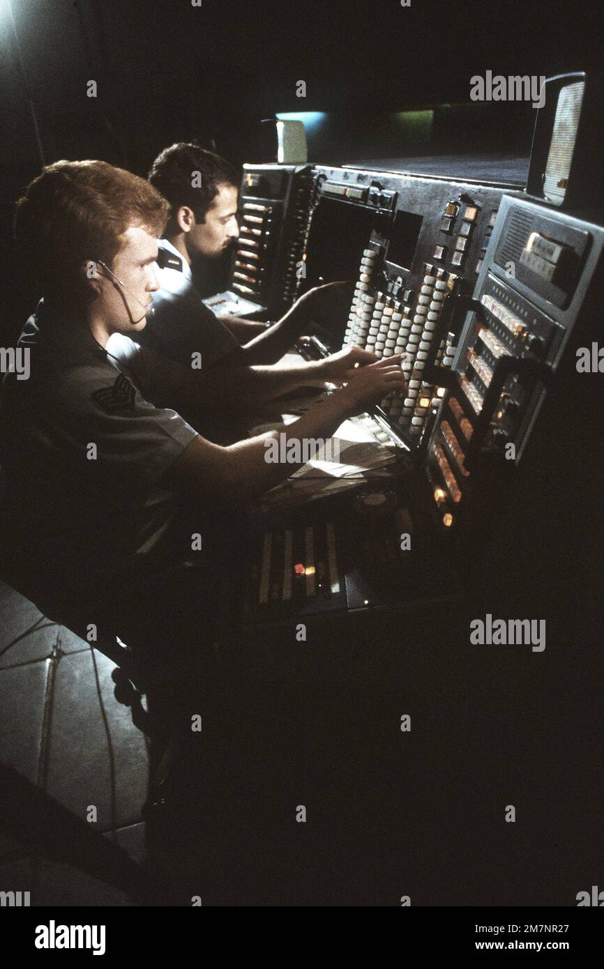A radar weapons controller team monitors a radar console for possible ...