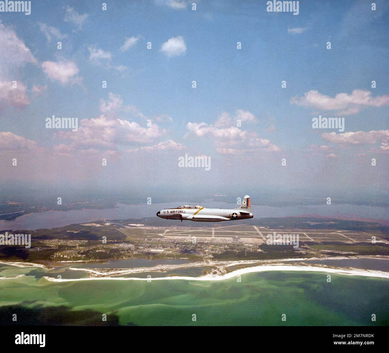 AN air-to-air left side view of a T-33A Shooting Star aircraft. Base ...