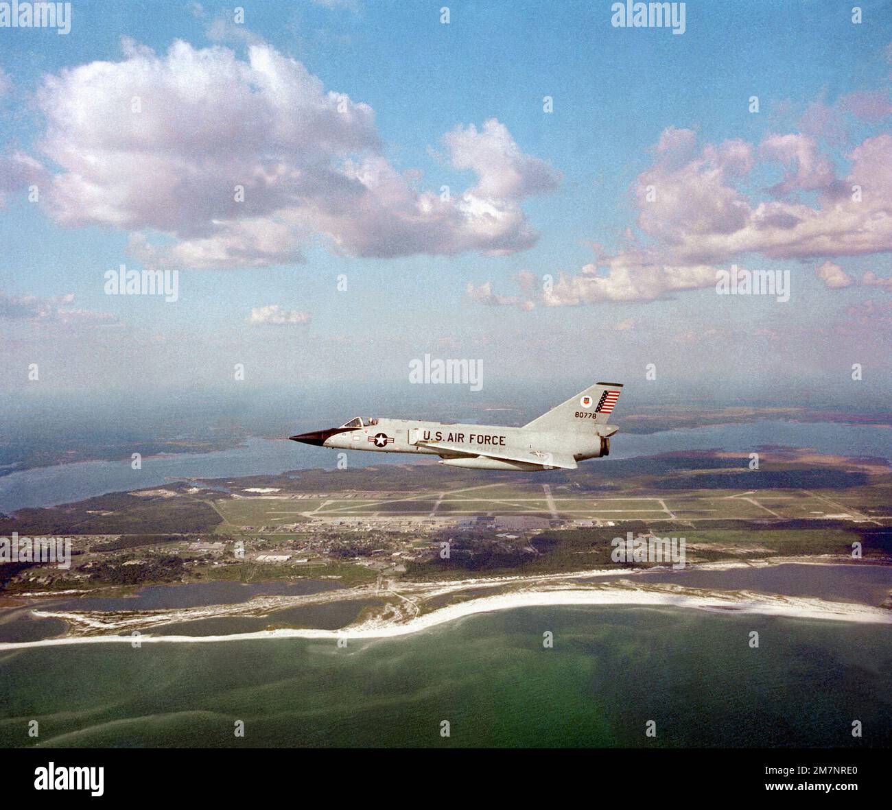 AN air-to-air left side view of an F-106A Delta Dart aircraft. Base ...