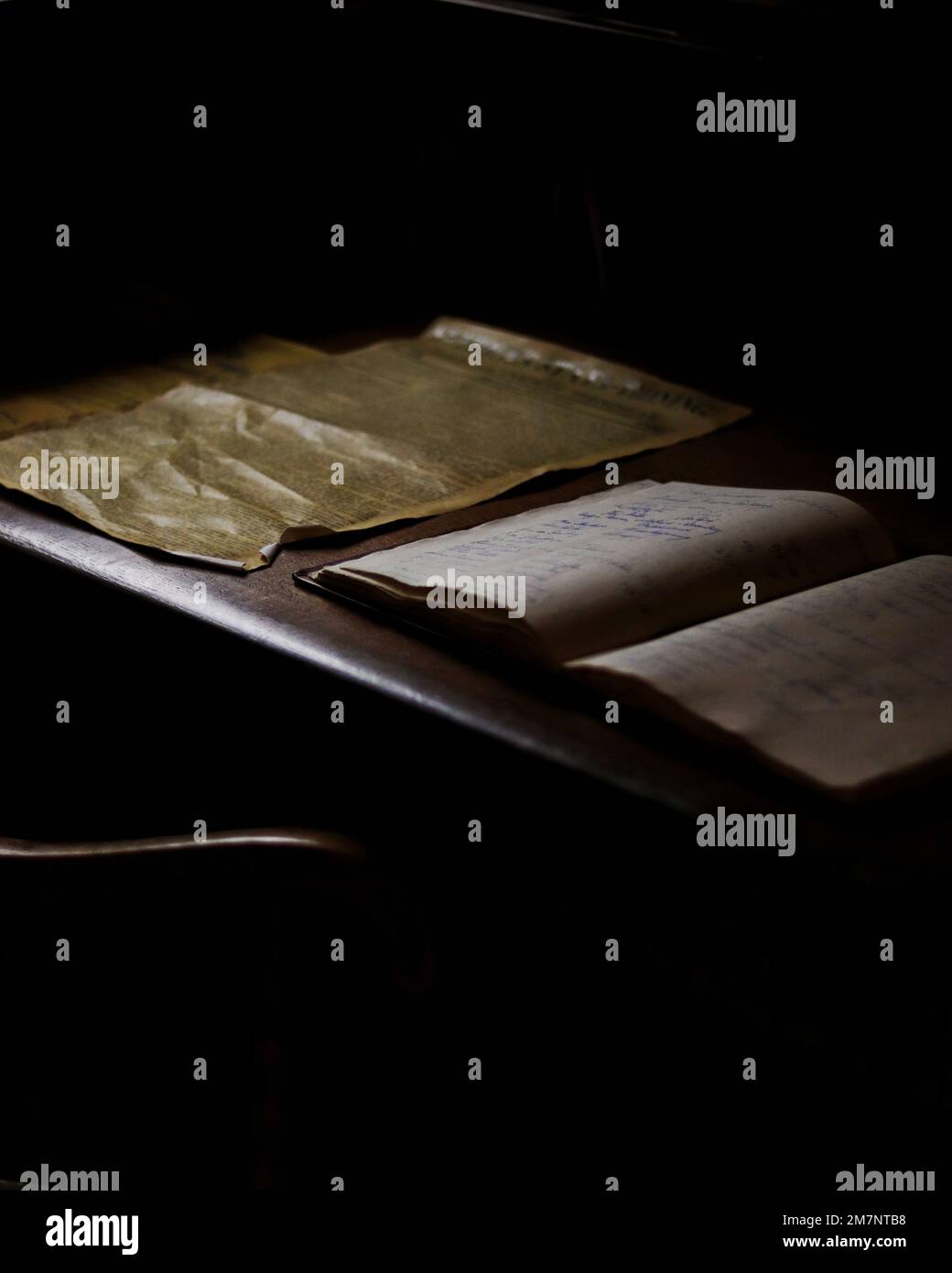 An open book and old paper on top of a wooden table Stock Photo - Alamy