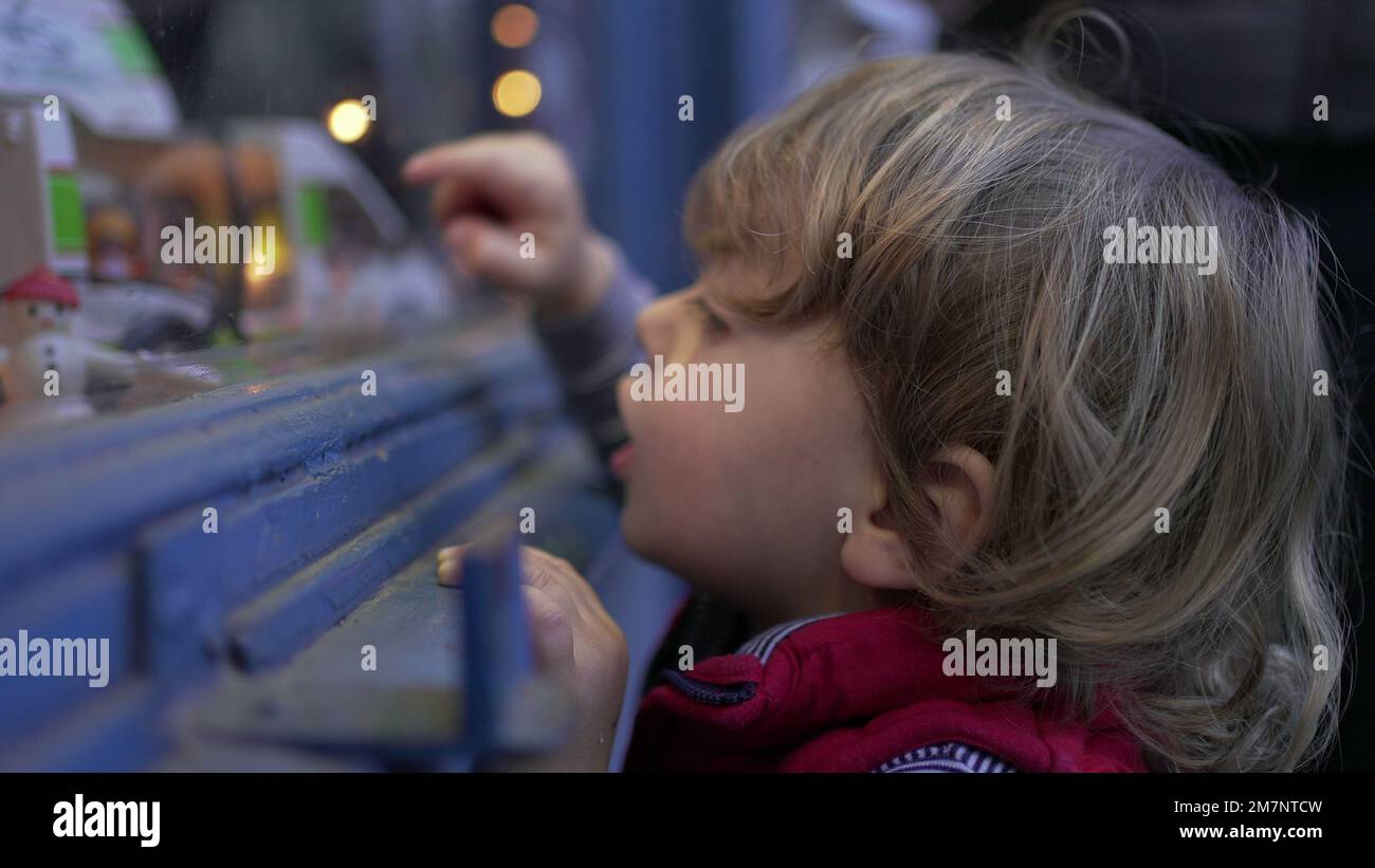 Child choosing product at grocery store window Stock Photo - Alamy