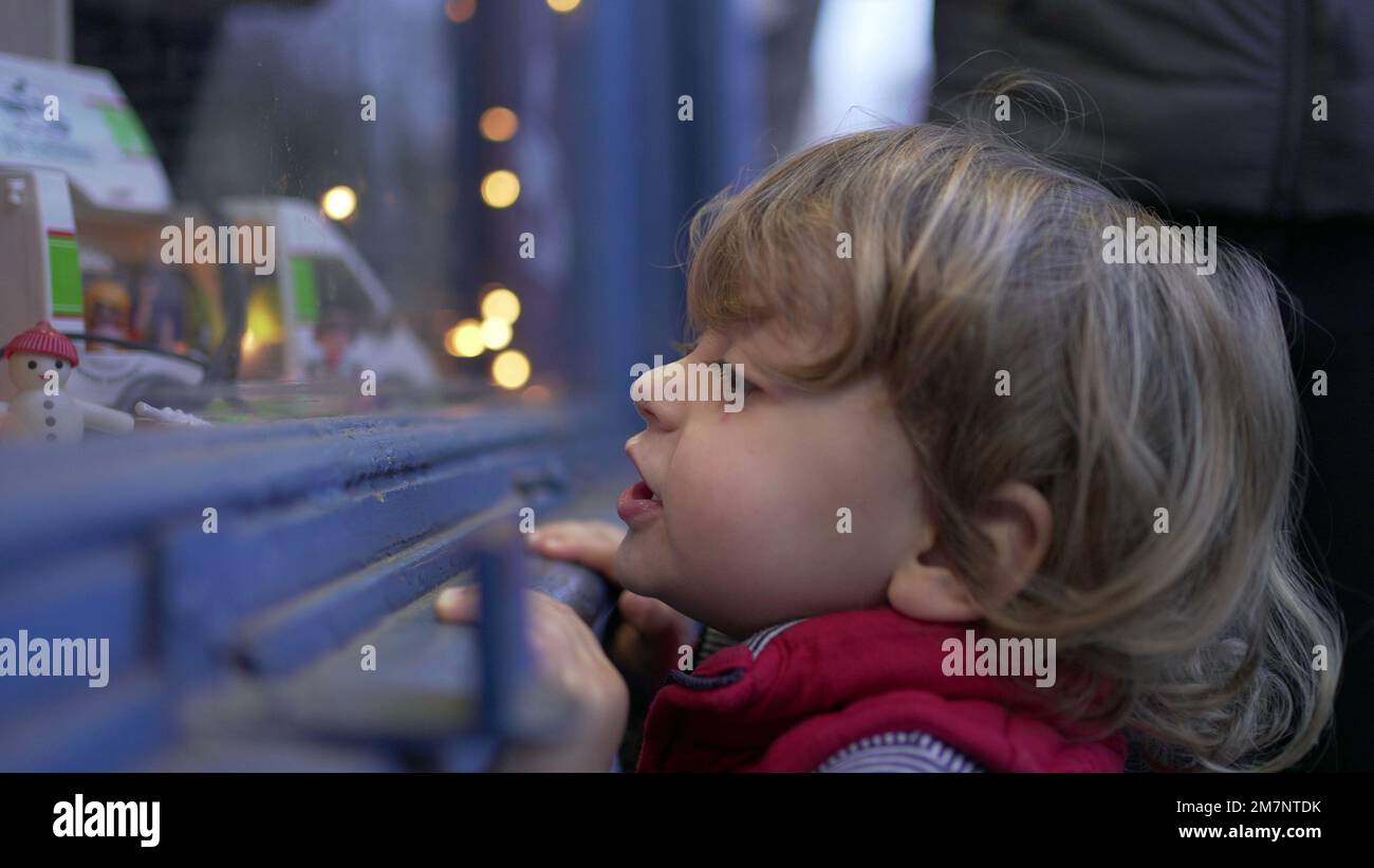 Child choosing product at grocery store window Stock Photo - Alamy