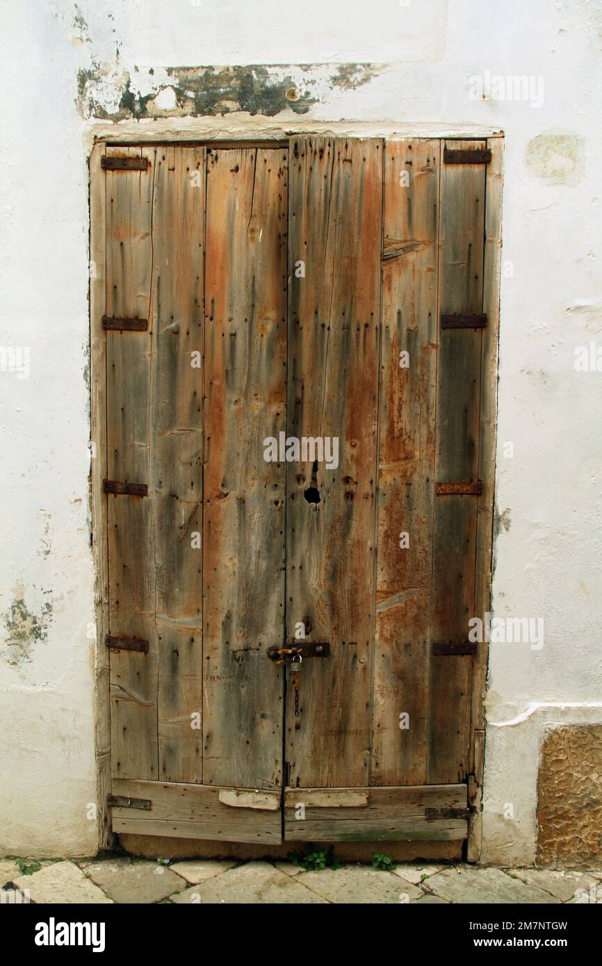 Simple wooden doors in the historical center of Racale, Italy Stock ...