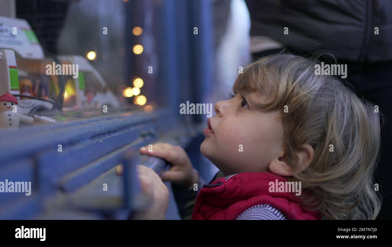Child jumping into water puddle. Toddler wearing boots splash into ...