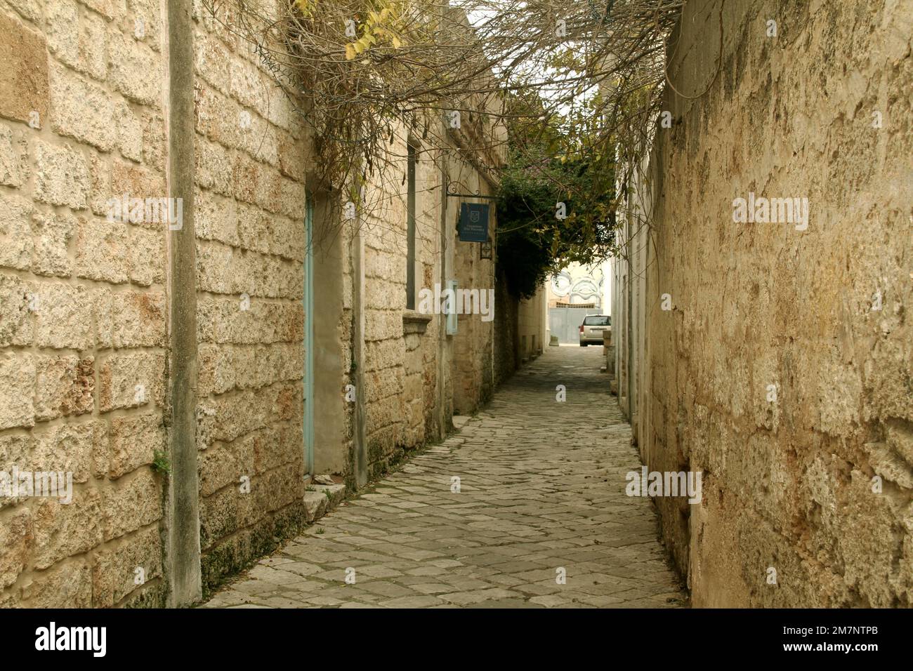 Racale, Italy. Narrow alleyway in the historical center with a natural ...