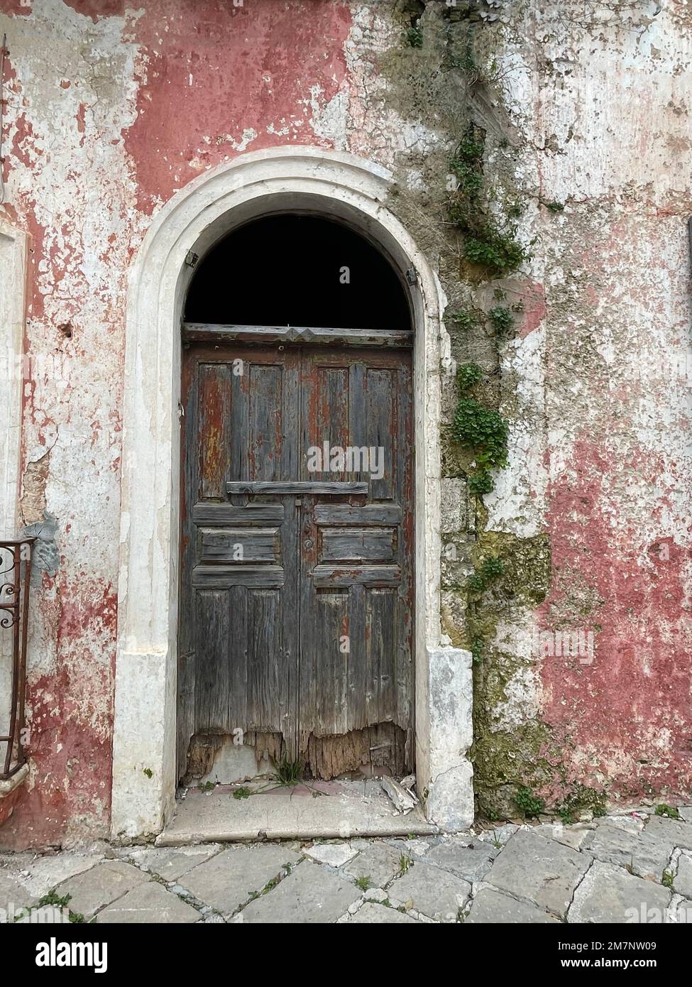 Entrance to an abandoned building in the historical center of Racale ...