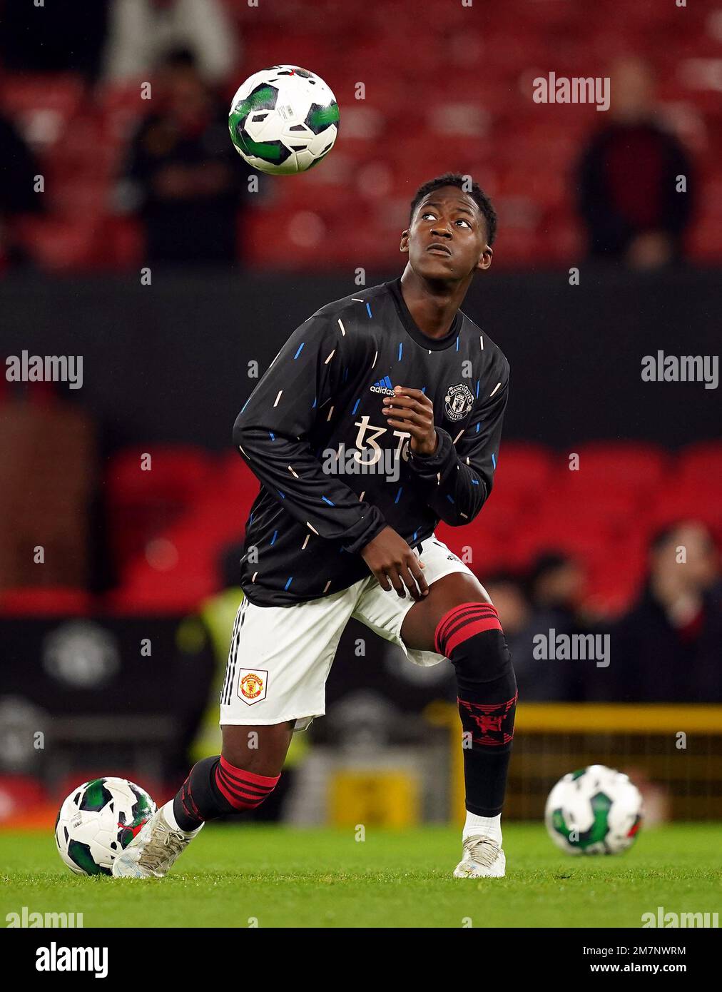 Manchester United's Kobbie Mainoo warms up before the Carabao Cup ...