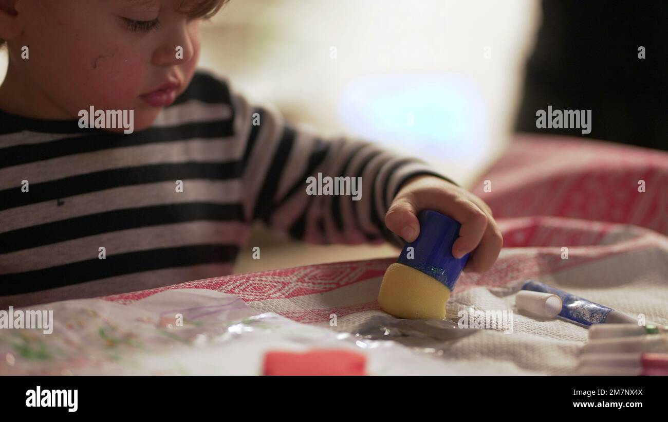 Baby playing with craft toys. Toddler plays with instrument toy Stock ...