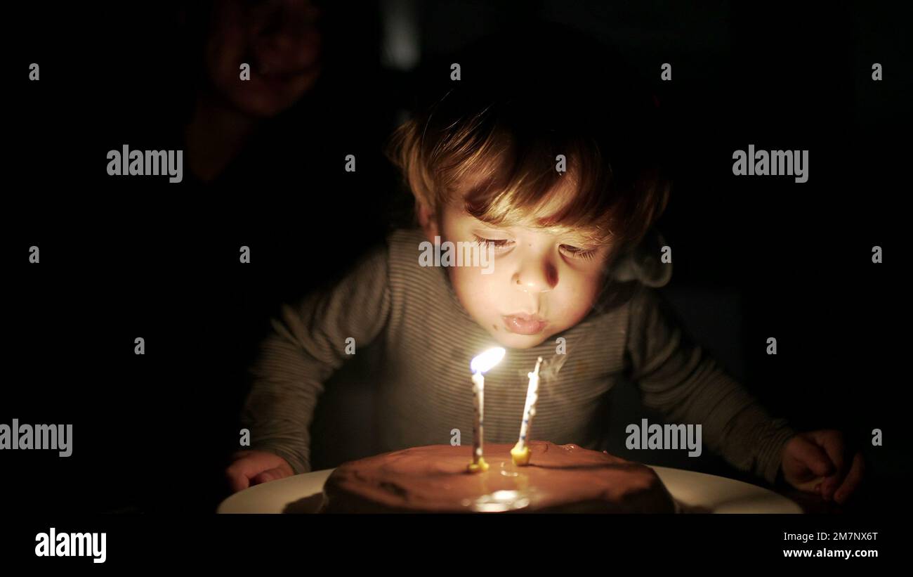 Baby toddler blowing birthday candles celebration. Two year old child ...