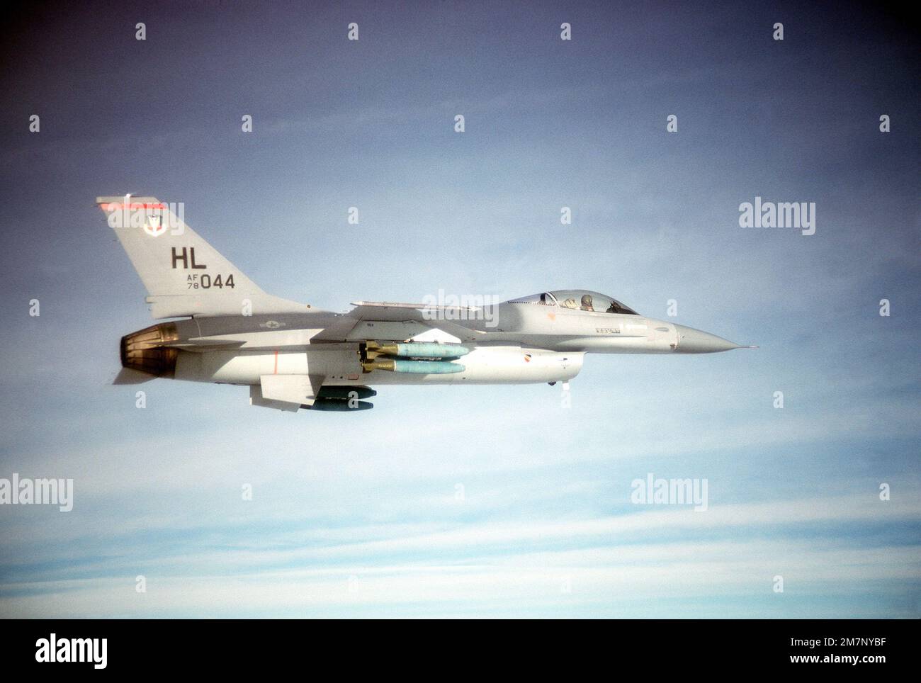AN air-to-air right side view of an F-16 Fighting Falcon aircraft armed ...