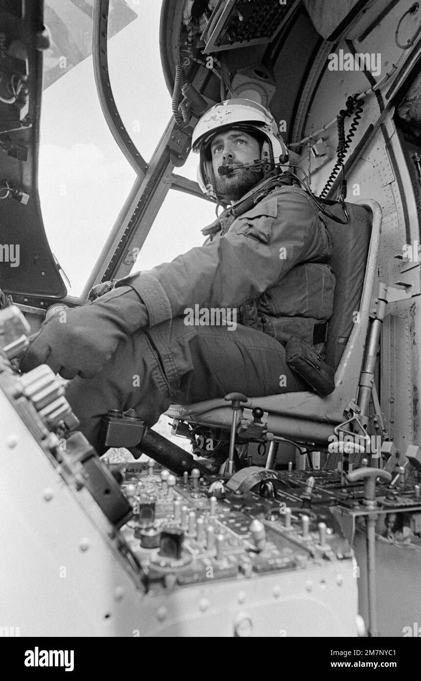 Lieutenant Junior Grade Michael G. Jegland, a pilot, in the cockpit of ...