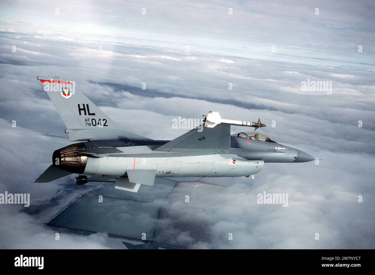 AN air-to-air right side view of an F-16 Fighting Falcon aircraft ...