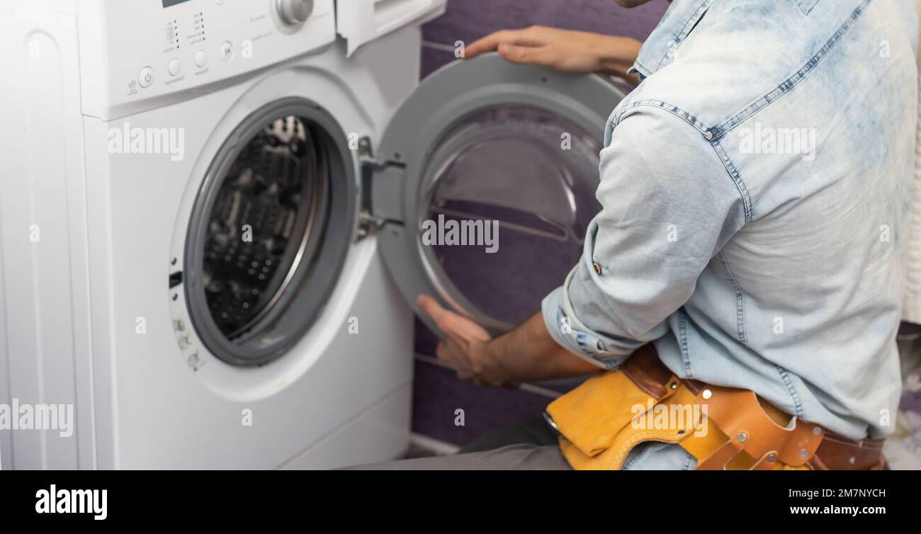 Man repairs washing machine hi-res stock photography and images - Alamy