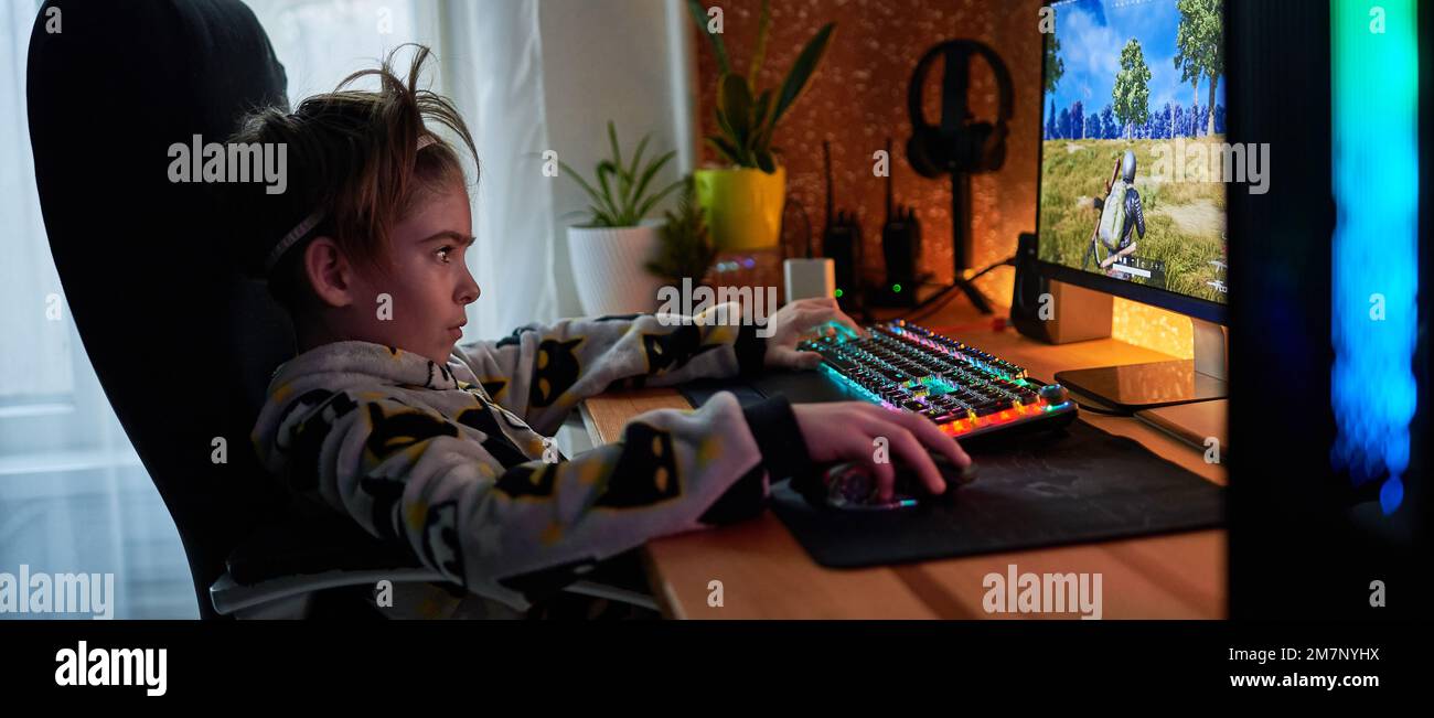 Image of immersed teenage gamer boy playing video games on computer in ...