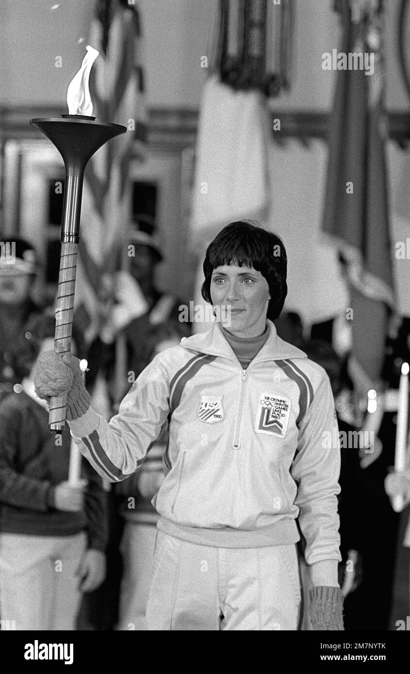 First Olympic torchbearer Sandy Norris, after her relay, stands at ...