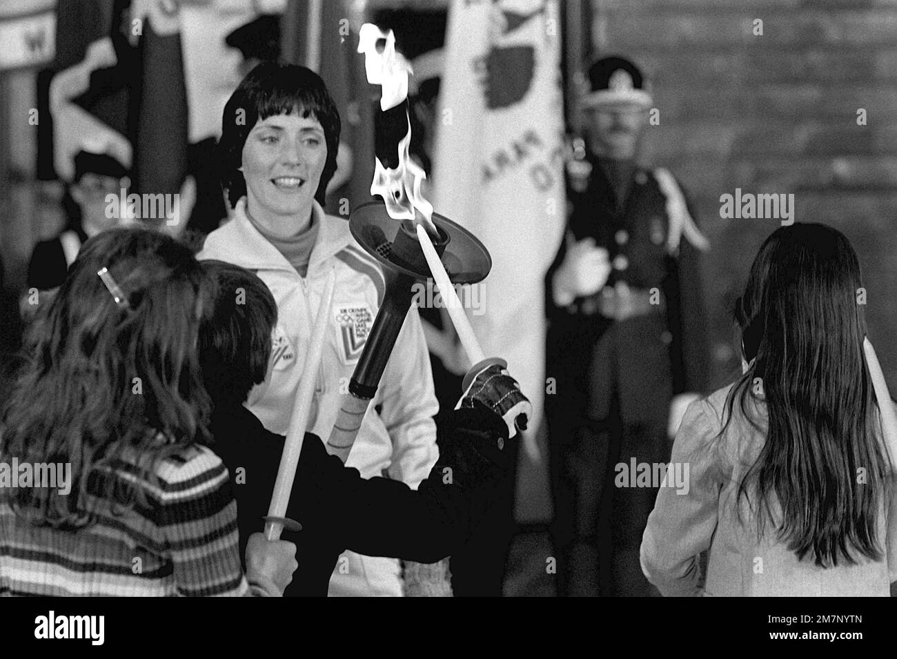 First Olympic torchbearer Sandy Norris, after her relay, stands at ...
