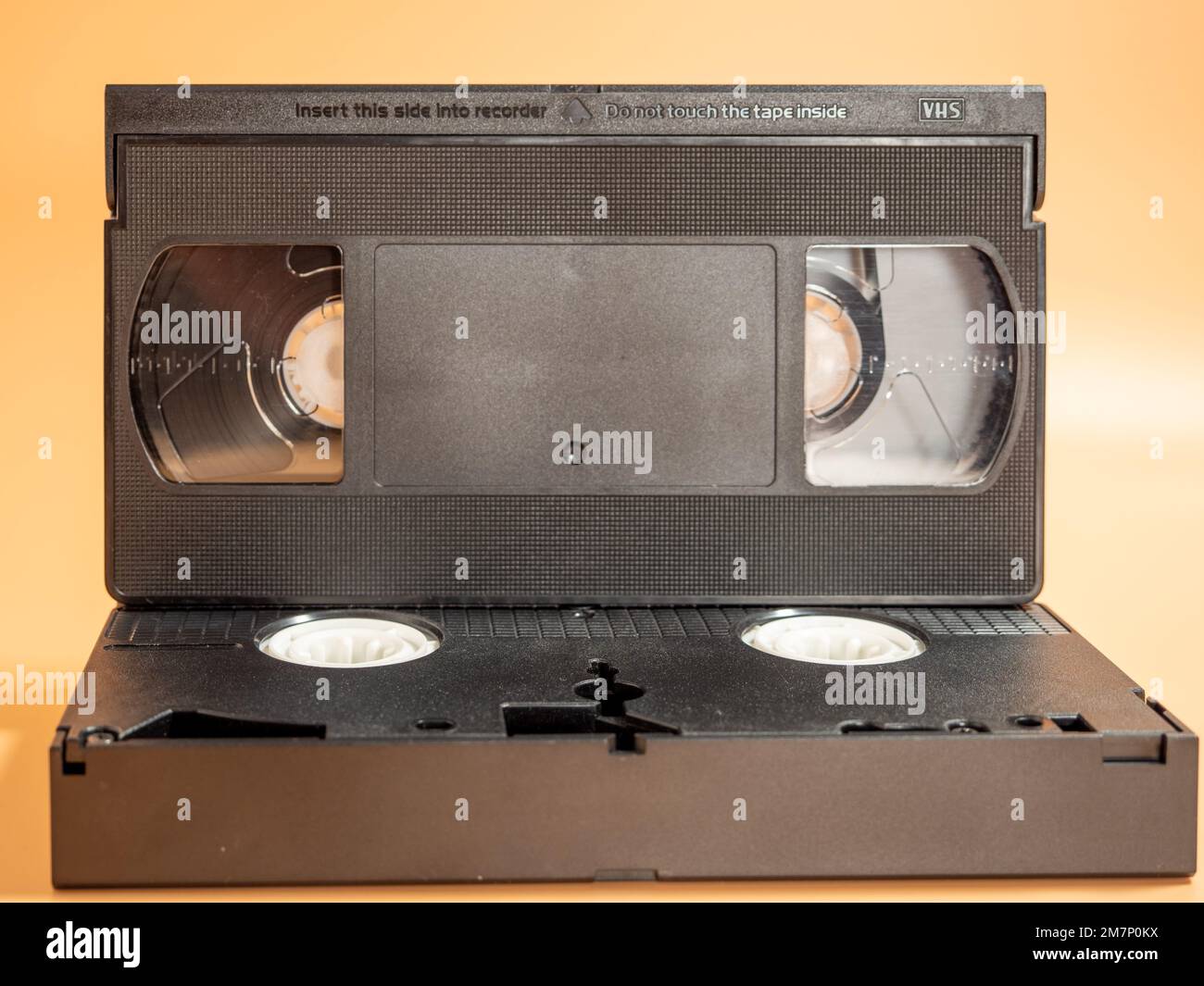 Old VHS cassettes on an orange background. Retro video cassettes. Close ...