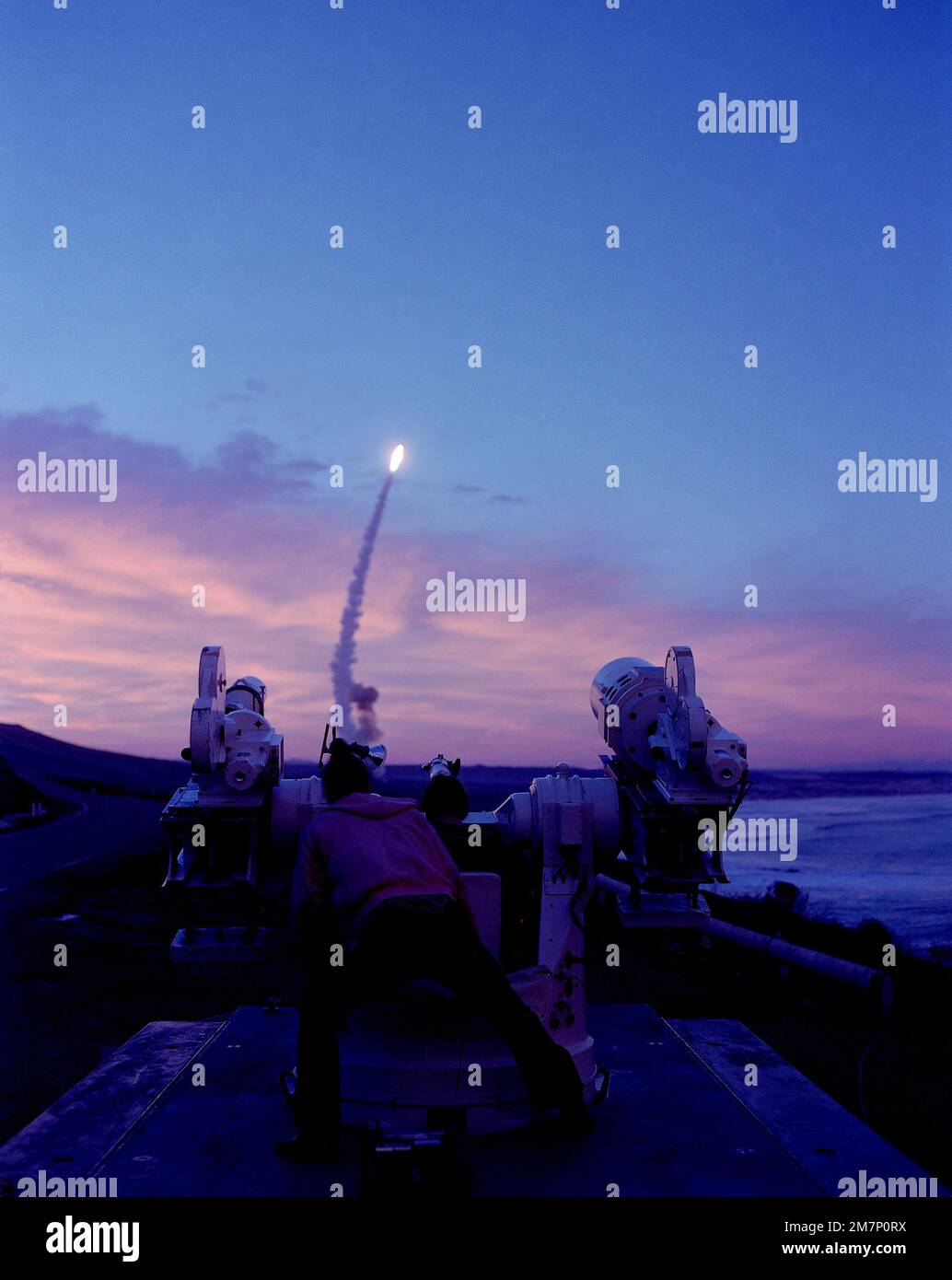 AN LGM-30G Minuteman III missile is being launched at dawn as a ...
