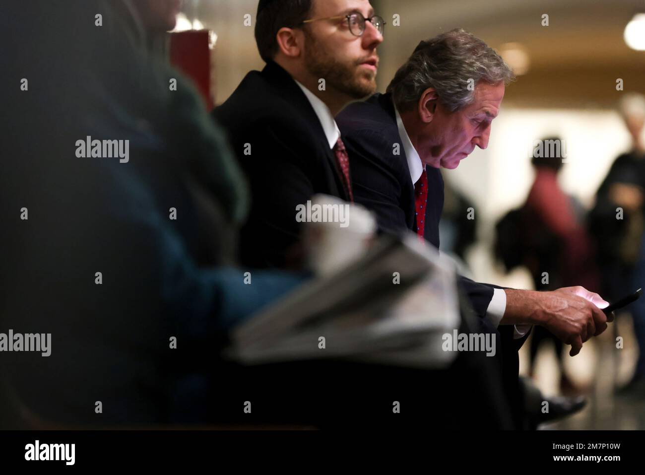 Defense attorney Michael van der Veen looks at his phone outside the courtroom during jury ...