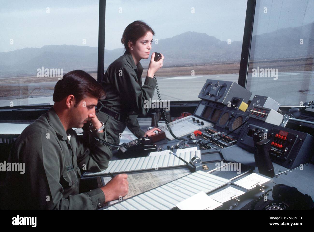A female U.S. Army air traffic controller gives instructions to ...