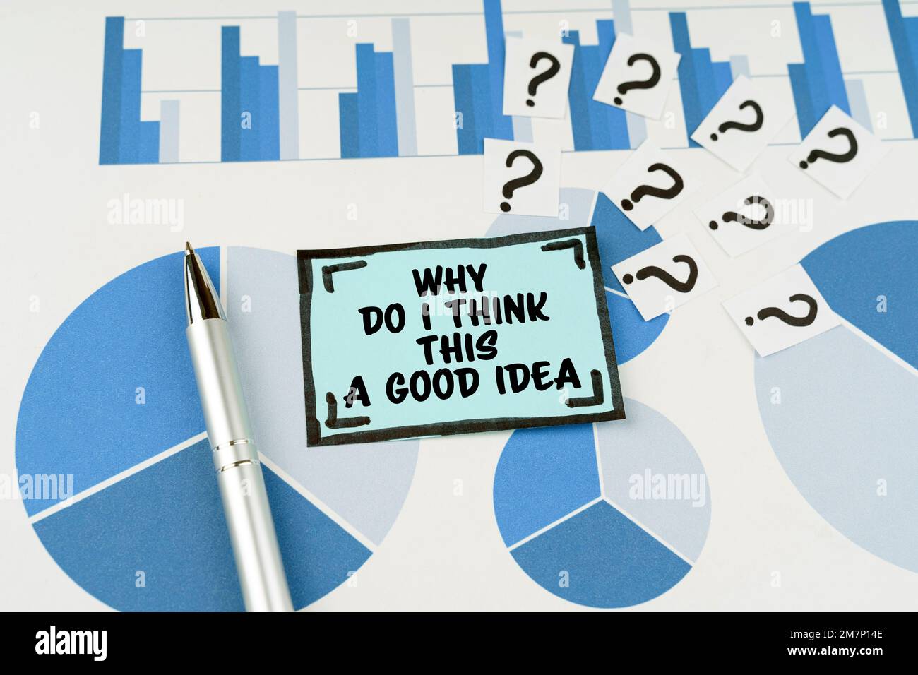 business question concept. On the blue diagrams lies a pen, questions ...