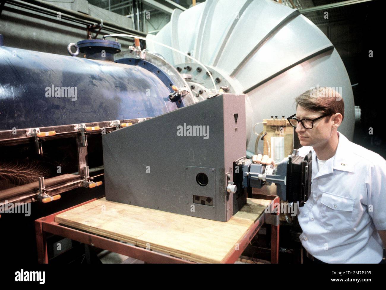 2LT Jeremy Thorne adjusts a spectrometer camera on an electron beam ...