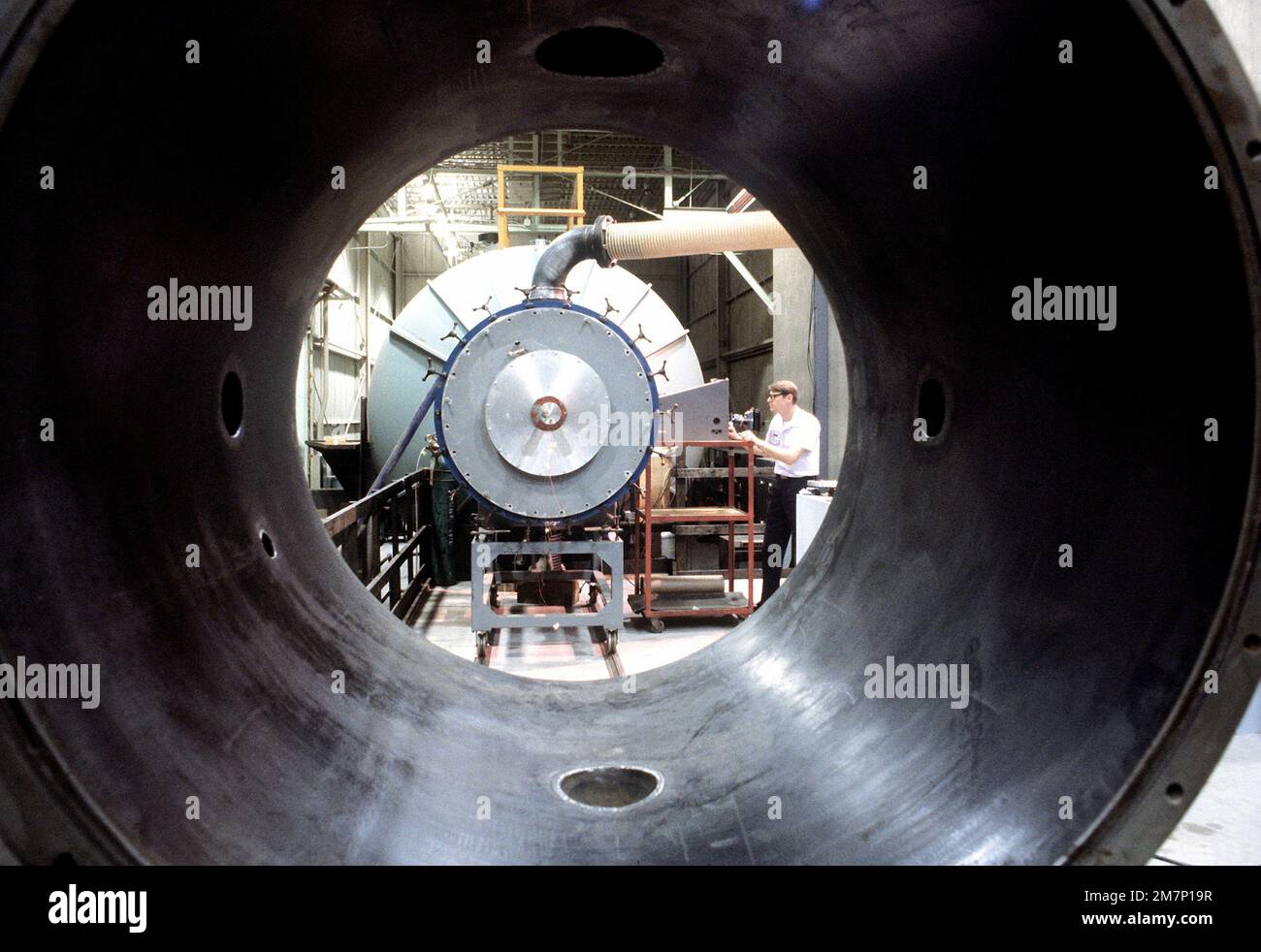 2LT Jeremy Thorne adjusts a spectrometer camera on an electron beam ...